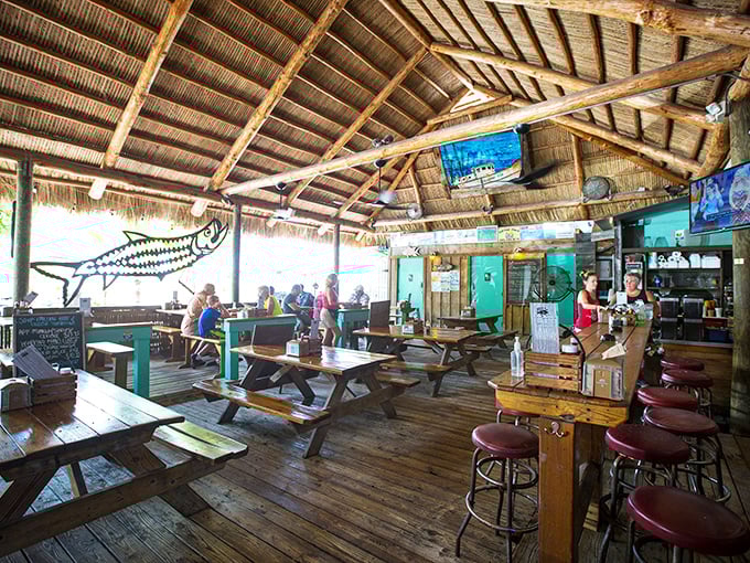 Inside, wooden picnic tables and an open-air design create the perfect "no shoes, no shirt, no problem" vibe that's increasingly rare in today's polished Florida.