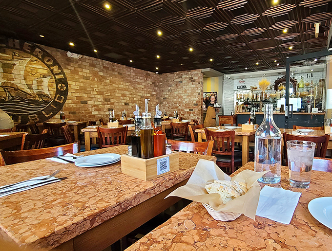 Warm brick walls, marble-topped tables, and that ceiling—a geometric masterpiece that makes you feel like you've stumbled into a Tuscan hideaway.
