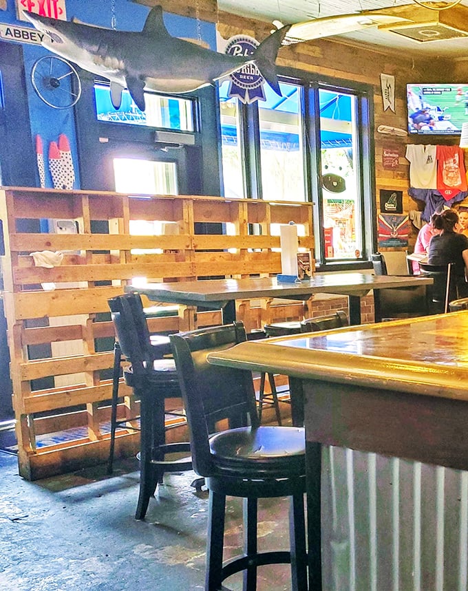 Rustic wooden dividers, a shark keeping watch overhead – this isn't fancy dining, it's fantastic dining.