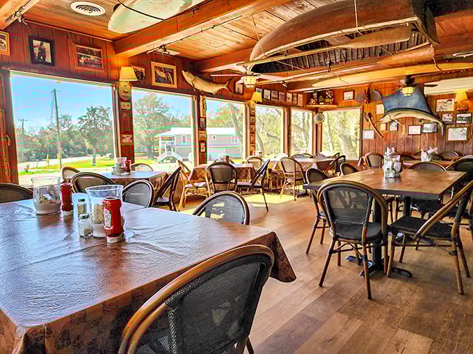 Warm wood paneling, natural light, and a boat hanging from the ceiling—this isn't interior design, it's a promise of maritime deliciousness to come.