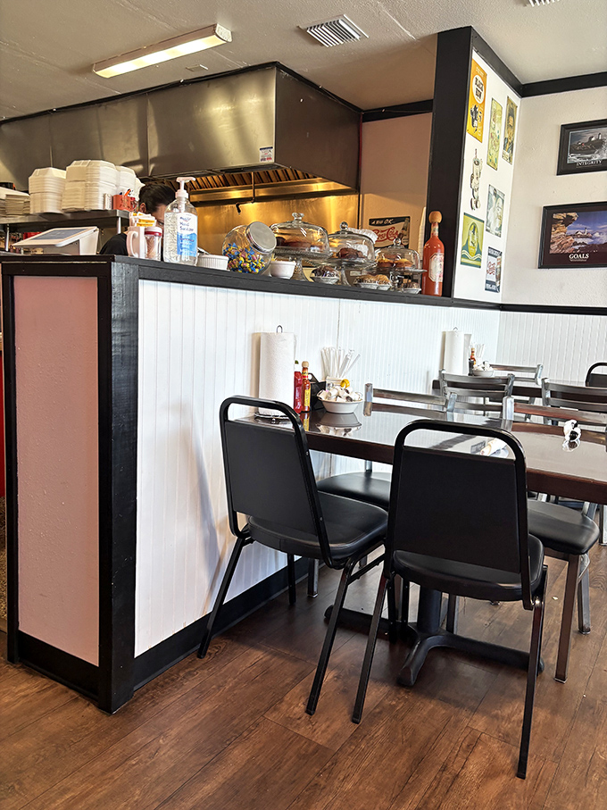 Classic diner aesthetics with those unmistakable black chairs and white wainscoting—where comfort begins before you even taste the food.