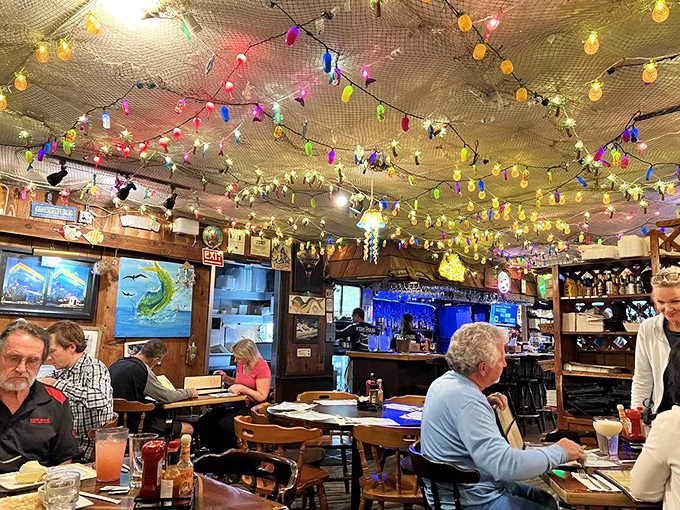 Step inside and you're greeted by a ceiling draped with fishing nets and twinkling lights – Florida Keys ambiance that's equal parts kitsch and magic.