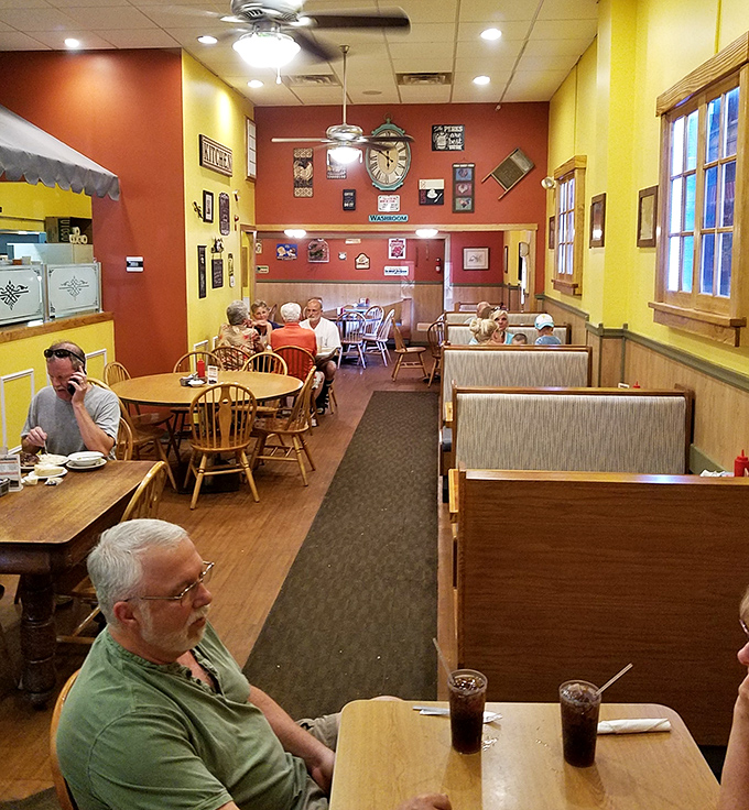 Warm yellow and red walls create that "everybody knows your name" atmosphere. The dining room feels like a community living room where food and conversation flow freely.