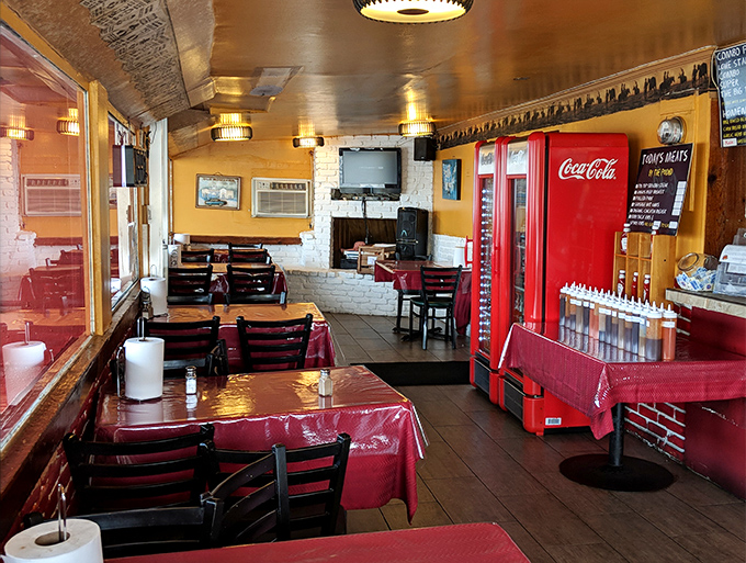 Yellow walls, red tablecloths, and that vintage Coca-Cola machine—this place understands BBQ ambiance is about comfort, not pretension.