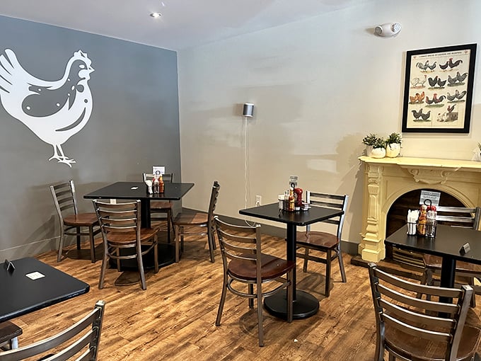 Inside, minimalist charm meets cozy comfort with the signature hen silhouette watching over diners like a breakfast guardian angel.