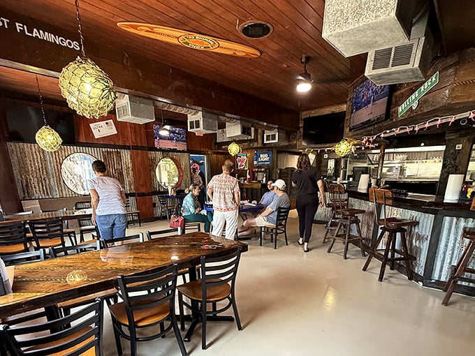 Inside, nautical meets neighborhood bar with weathered wood, hanging glass floats, and corrugated metal that whispers tales of storms weathered and grouper grilled to perfection.