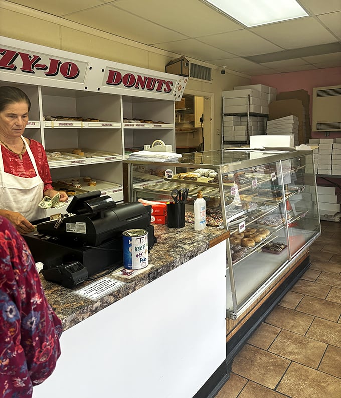 Behind the counter, where donut dreams come true. This no-frills setup focuses on what matters—getting fresh pastries into eager hands.
