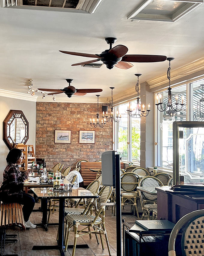 Exposed brick walls and bistro chairs create that perfect "where everybody knows your name" vibe—minus Norm and Cliff at the bar.