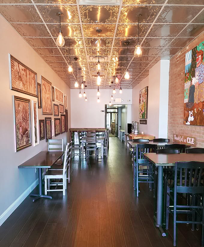 Edison bulbs dangle from a stunning pressed tin ceiling, creating the perfect ambiance for contemplating life's most important question: "Which donut next?"