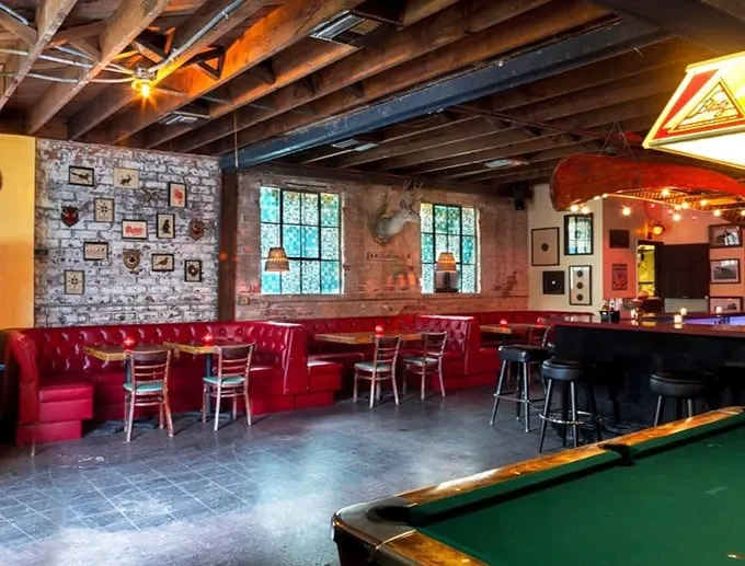 Red vinyl booths, exposed beams, and weathered brick walls create the perfect backdrop for the serious business of chicken consumption.