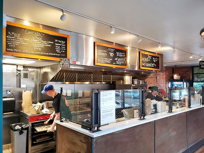 Where the magic happens! The open kitchen design lets you witness the fried chicken alchemy that transforms simple ingredients into gold.