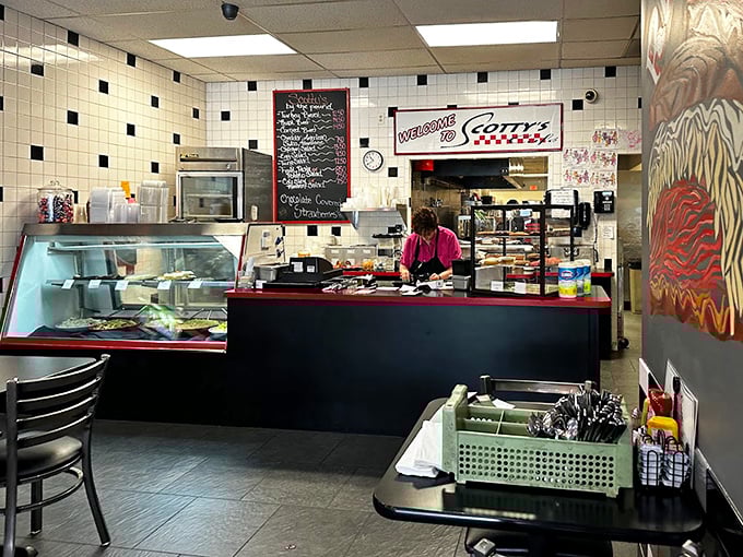 Behind the counter, where magic happens daily, the classic black-and-white tiled walls whisper of diners past while promising comfort food futures.