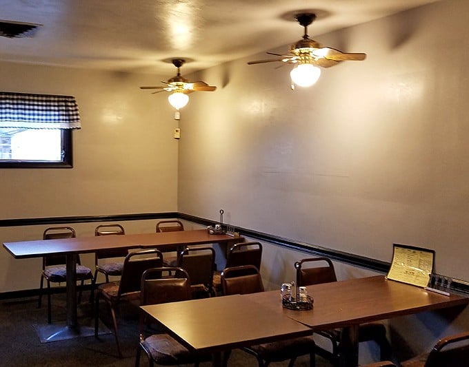 Simple tables, ceiling fans, and checkered valances create the perfect backdrop for serious sandwich consumption. Comfort trumps trendiness every time.