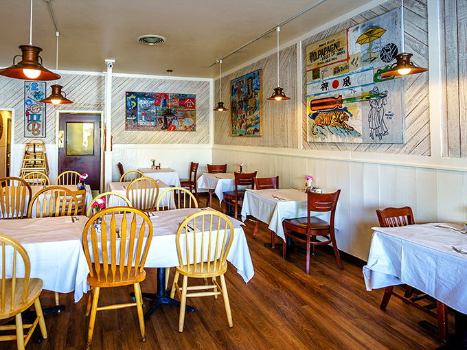 Wooden chairs, white tablecloths, and coastal artwork create that perfect "I've discovered something special" feeling that makes you want to text friends immediately.