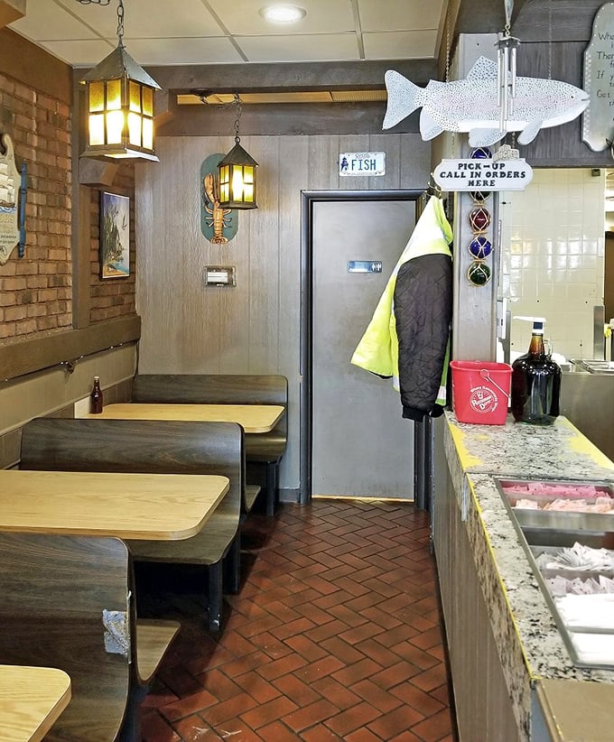 Nautical charm meets no-nonsense dining. The hanging lanterns and metal fish silhouette create an atmosphere that says "we're serious about seafood."