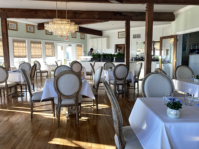 Sunlight dances across polished wood floors while elegant chairs await diners seeking both refinement and relaxation—no jacket required, just an appetite.