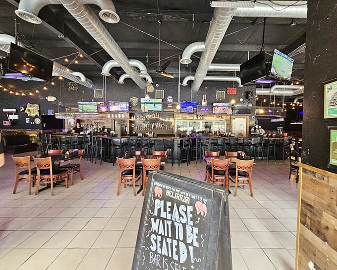 Industrial-chic meets comfort food haven. The exposed ductwork and string lights create the perfect backdrop for impending food euphoria.
