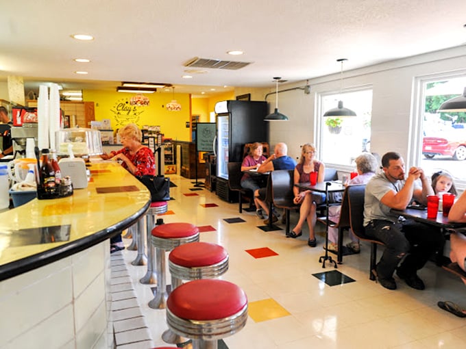 Classic Americana comes alive inside with cherry-red counter stools, checkerboard floors, and the kind of yellow walls that make everyone look like they're glowing.