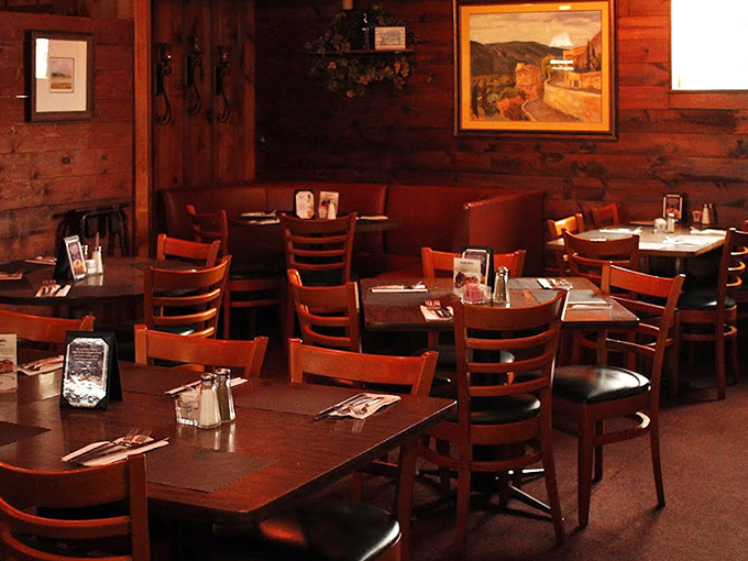 Warm wood paneling and cozy red booths create that classic steakhouse ambiance where memories are made and prime rib dreams come true.