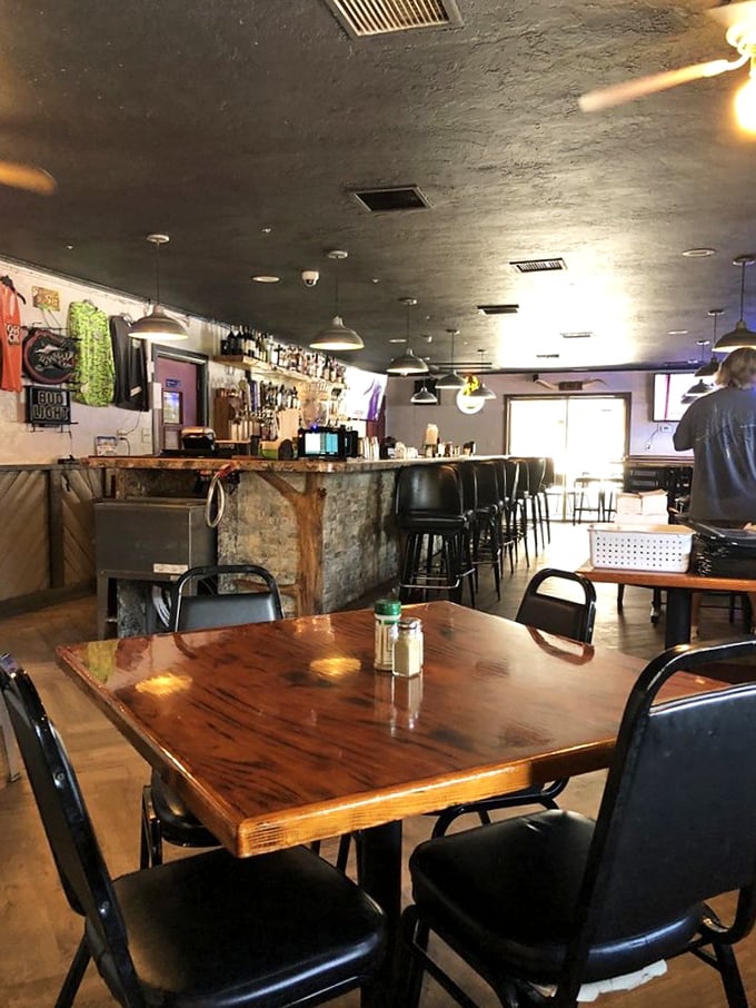 Inside, polished wood tables and a well-stocked bar create the perfect backdrop for culinary adventures. Comfort meets character in this unpretentious dining space.