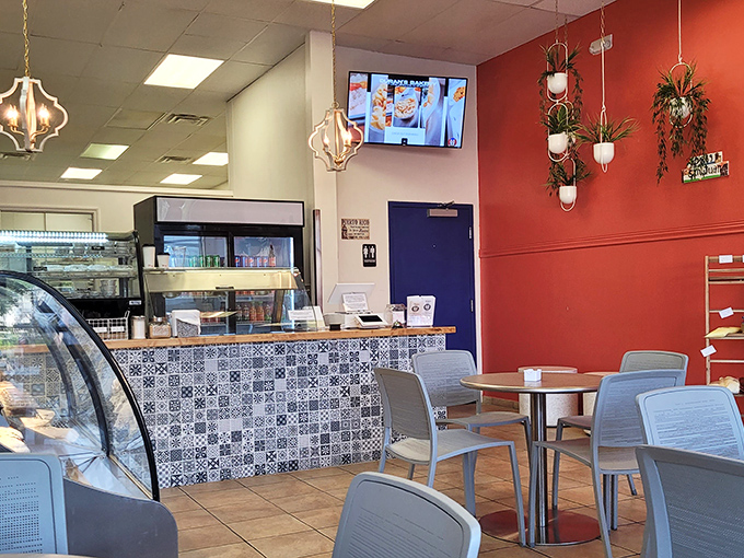 Inside, vibrant red walls and hanging plants create that perfect balance between "trendy breakfast spot" and "place where you can actually hear your conversation."