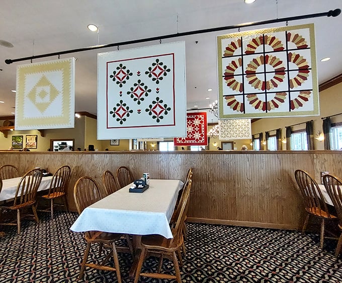Handcrafted quilts hang from the ceiling, telling stories of tradition while you contemplate which comfort food to tackle first.