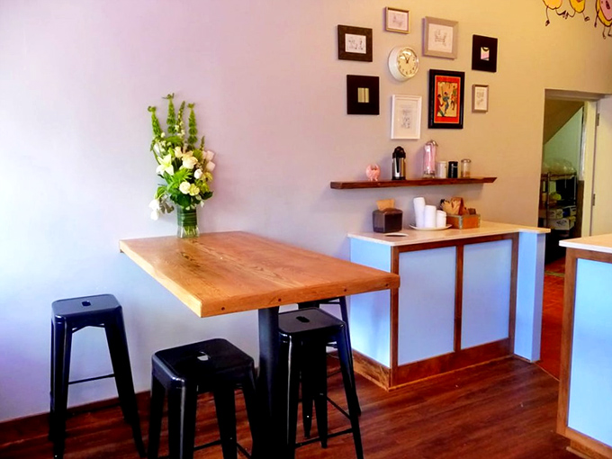 Minimalist charm meets cozy comfort in this light-filled space, where wooden tables and gallery walls invite you to linger over coffee.