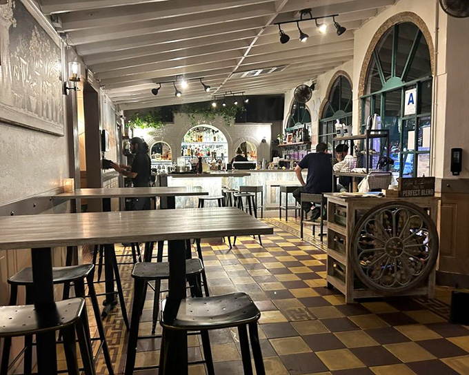 Inside, the checkerboard floors and arched windows create a space that feels both timeless and welcoming—like Hemingway's living room, but with better food.