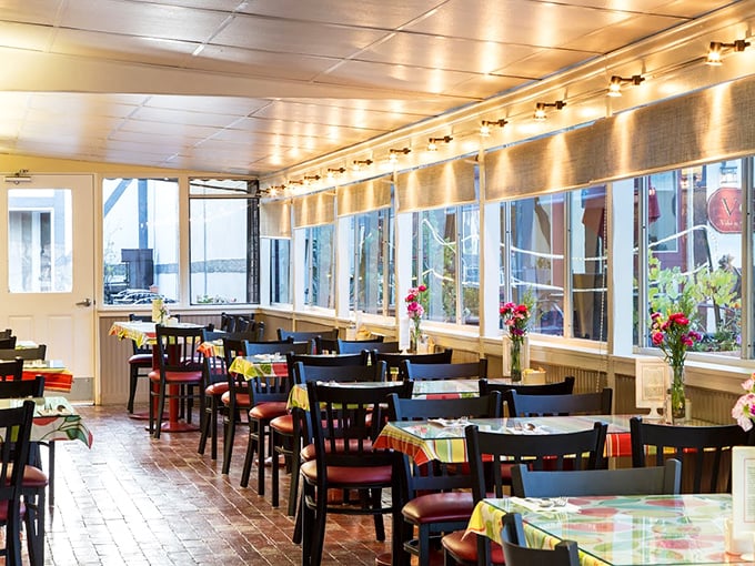 Sunlight streams through windows onto colorful tablecloths, creating the kind of cozy atmosphere where calories don't count and coffee refills are mandatory.