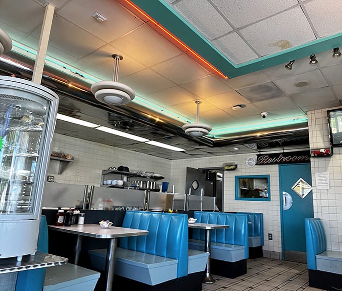Classic turquoise booths invite you to slide in and stay awhile. This isn't just a diner—it's a time machine with better coffee and no complicated controls.