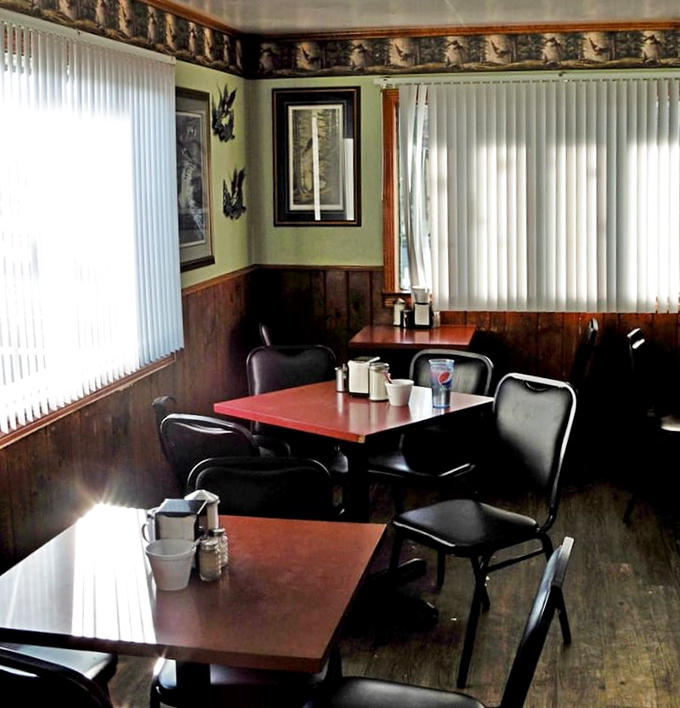 Wood paneling, wildlife prints, and tables set for conversation – this isn't retro by design, it's authentic by persistence.