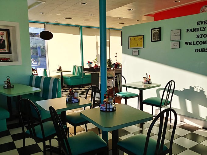 The checkerboard floor and turquoise booths aren't just decoration—they're portals to simpler times when conversations happened face-to-face and calories didn't count.
