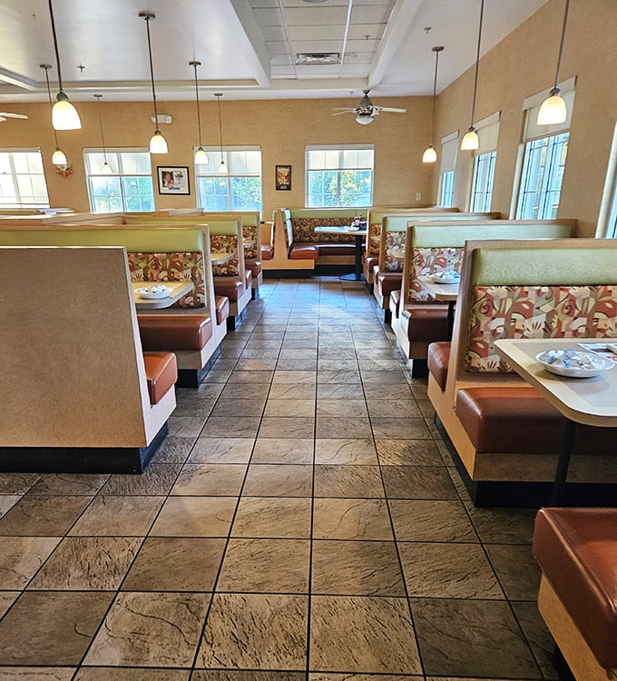 Classic diner geometry: floral-patterned booths, warm pendant lighting, and that unmistakable feeling you've just walked into somewhere that knows exactly what it's doing.