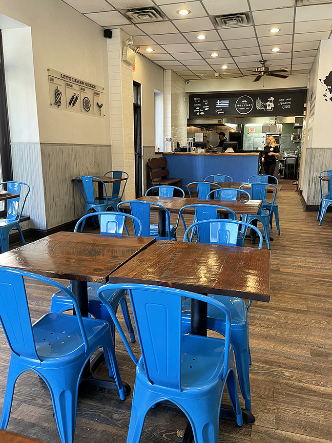 Blue chairs against rustic wood tables create that perfect Mediterranean vibe. You're not in Athens, but your taste buds will certainly think they've taken a Grecian holiday.