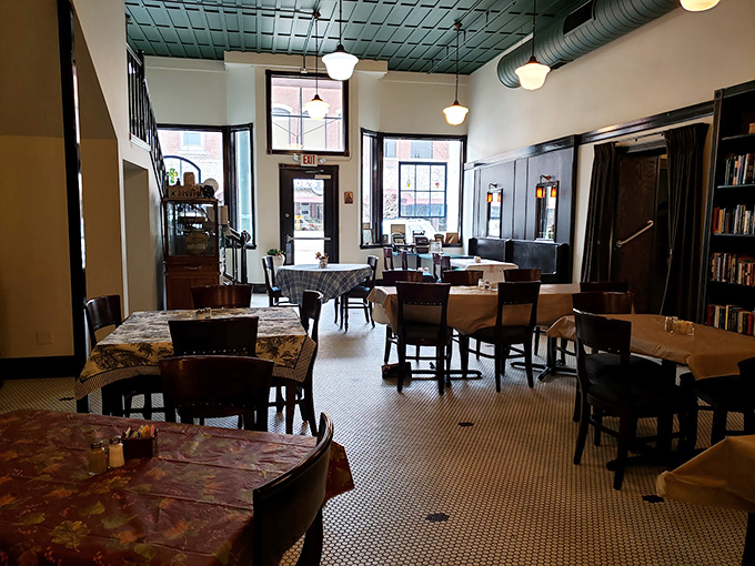 Step into a bygone era where hexagonal tile floors, tin ceilings, and cloth-covered tables create the perfect backdrop for conversations that unfold without smartphone interruptions.