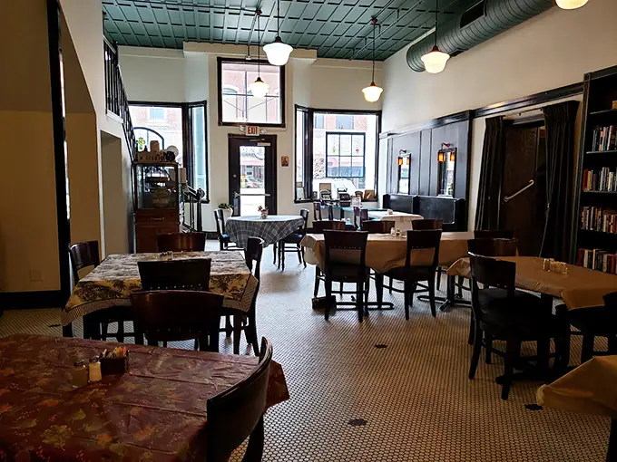 Step into a bygone era where hexagonal tile floors, tin ceilings, and cloth-covered tables create the perfect backdrop for conversations that unfold without smartphone interruptions.