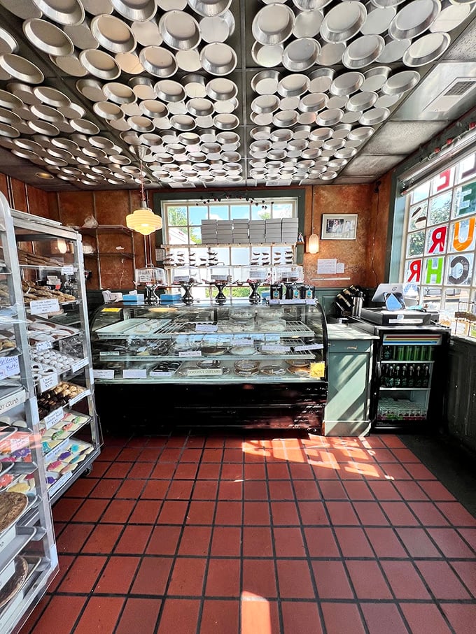 Pie tins create a metallic canopy overhead, like a dessert constellation guiding hungry travelers to their sweet destiny.