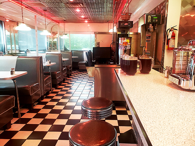 Step inside and the checkerboard floor practically plays chess with your senses, while those red vinyl booths beckon with promises of comfort food glory.