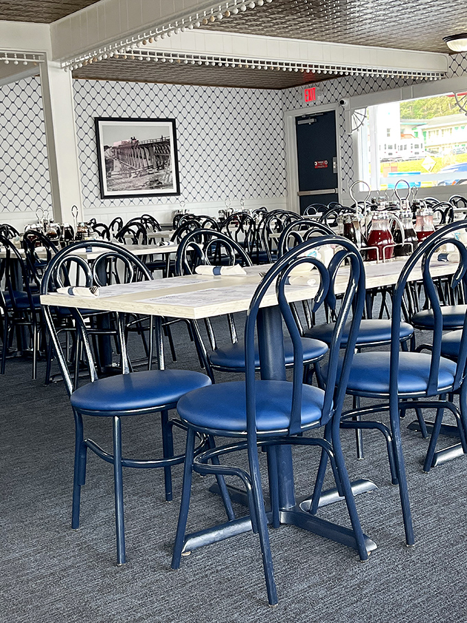Blue chairs and marble-topped tables create a classic diner atmosphere where breakfast dreams come true. History on the walls, pancakes on the plates.