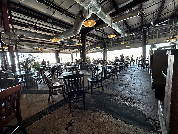 Industrial chic meets coastal comfort in this spacious dining room where concrete floors echo with satisfied diners.