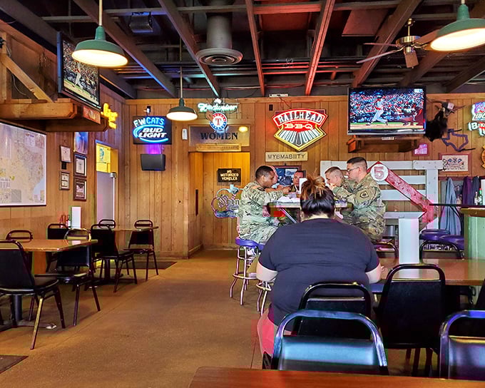 Where beer signs glow, TVs flicker, and wood-paneled walls tell stories of countless barbecue pilgrimages. This is Texas comfort in its natural habitat.