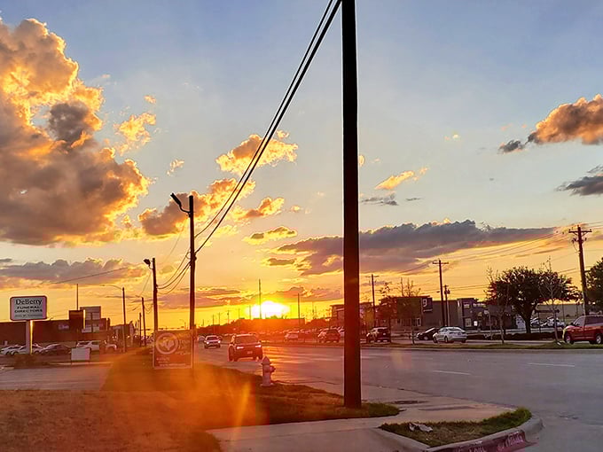 Texas sunsets don't just happen—they perform. This golden hour spectacle transforms ordinary streets into pathways paved with liquid amber.