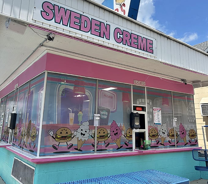 Cartoon hamburgers and ice cream cones dance across the windows, setting the stage for the joy that awaits inside this pink-trimmed time capsule.
