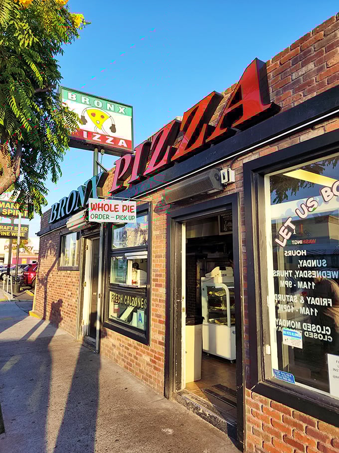 Bronx Pizza keeps it real with no-nonsense New York attitude. That sign promises authentic slices that would make a Manhattan cabbie feel at home.