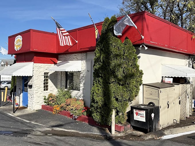 Gabby's stone fortress of flavor stands proud with its American flag – a patriotic salute to burger perfection.