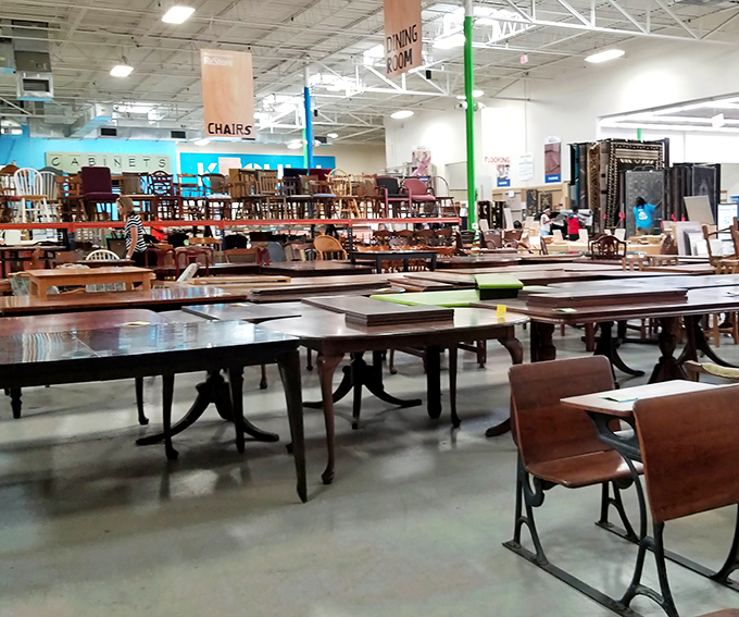 Dining tables stretch into the distance at Habitat ReStore—more options than a restaurant hostess could handle!