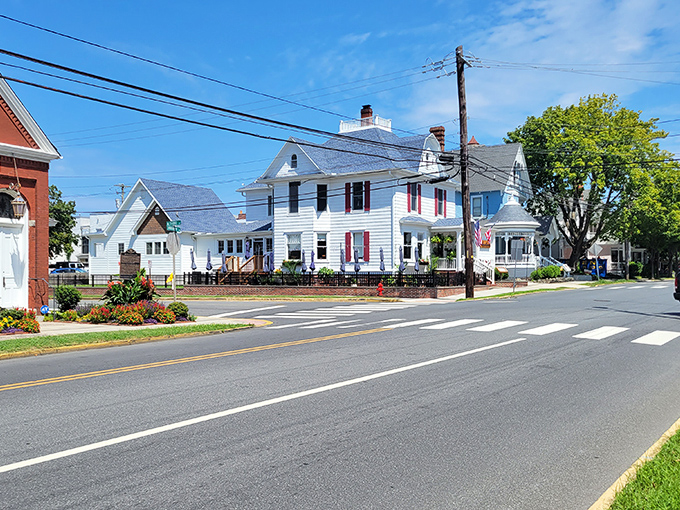Classic white homes with red shutters line Lewes' historic streets – a postcard-perfect scene that whispers stories from Delaware's colonial past.