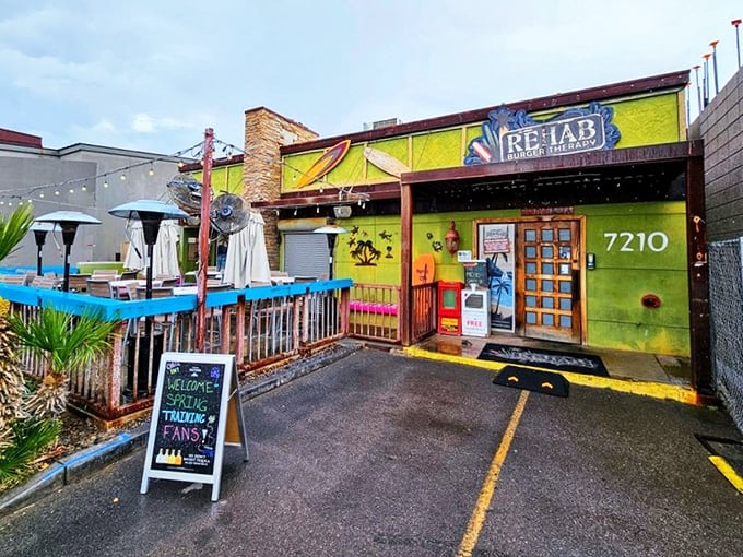 Rehab Burger Therapy's vibrant green facade is like a neon sign saying "Vacation vibes and burger bliss ahead!" No prescription needed.