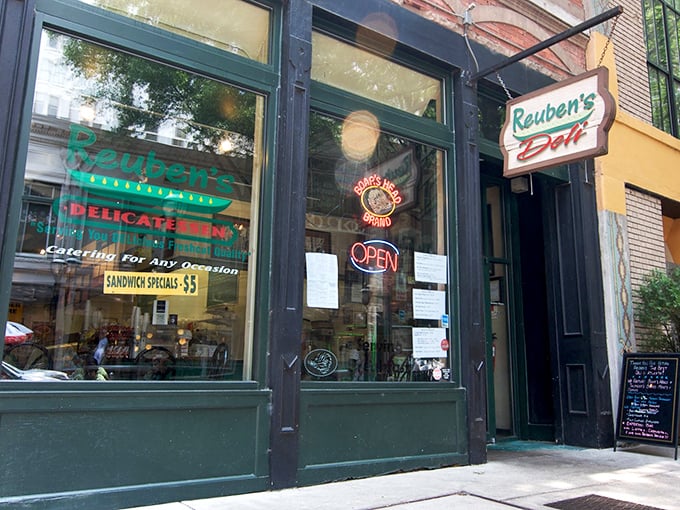 Reuben's storefront whispers of deli history, where sandwich artistry happens behind those green-trimmed windows.