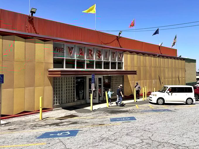 The Varsity stands proud like a retro palace, flying its flags high – an Atlanta landmark serving nostalgia between buns.